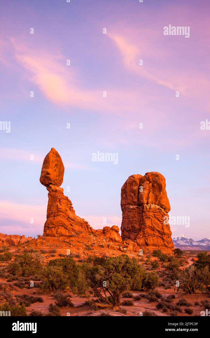 Post-sunset view of Balanced Rock and the snow-capped La Sal Mountains ...