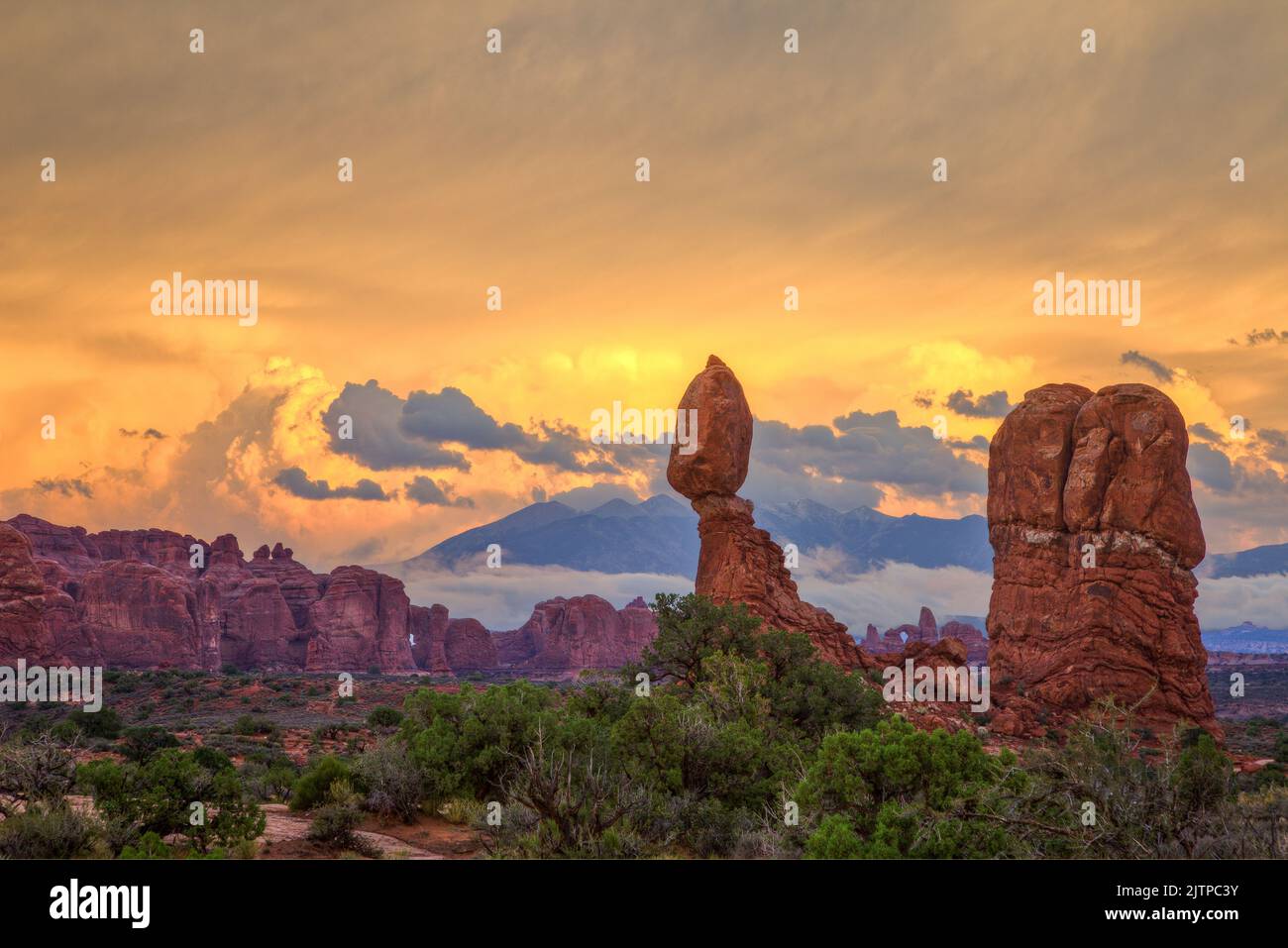 Post-sunset view of Balanced Rock and the snow-capped La Sal Mountains ...