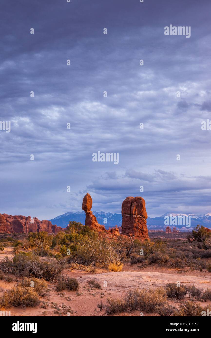 Pastel overcast view of Balanced Rock and the snow-capped La Sal ...