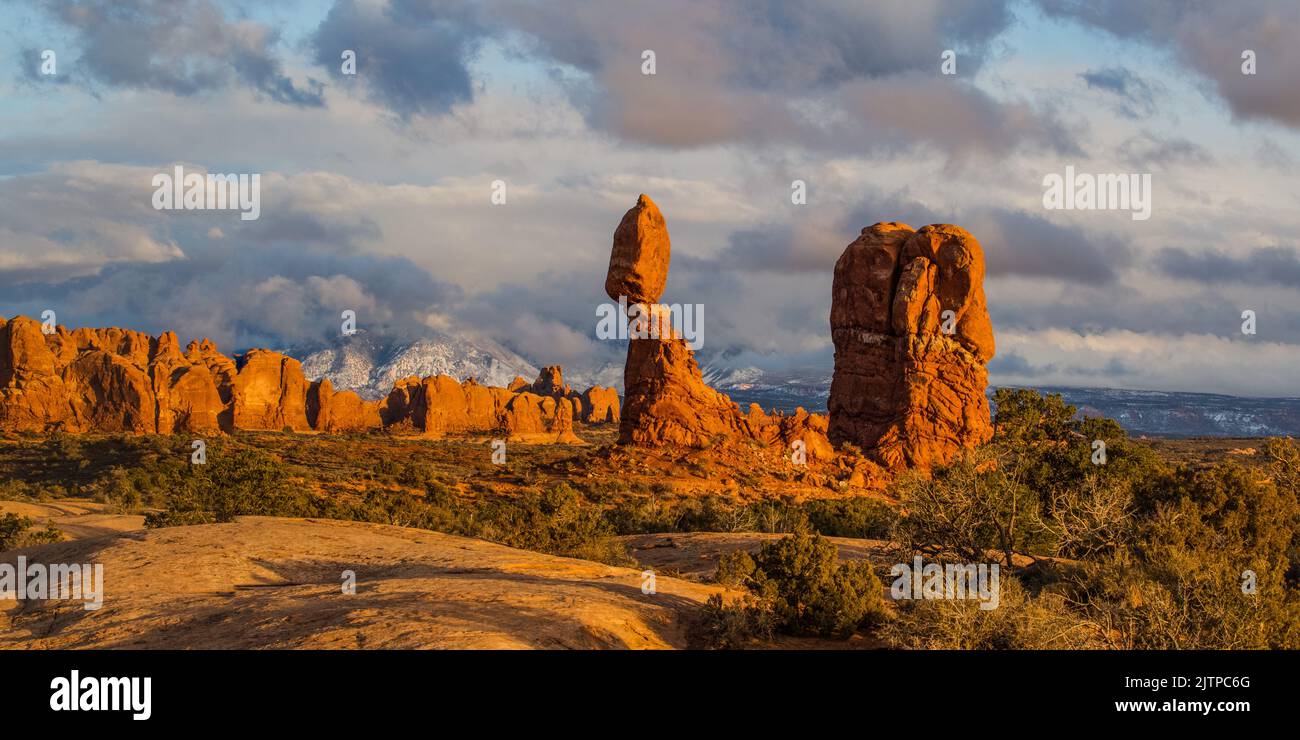 Balanced Rock at sunset in Arches National Park near Moab, Utah. In the background are the La ...