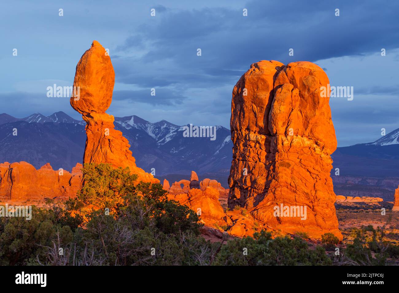 A telephoto view of Balanced Rock with Turret Arch and the La Sal ...