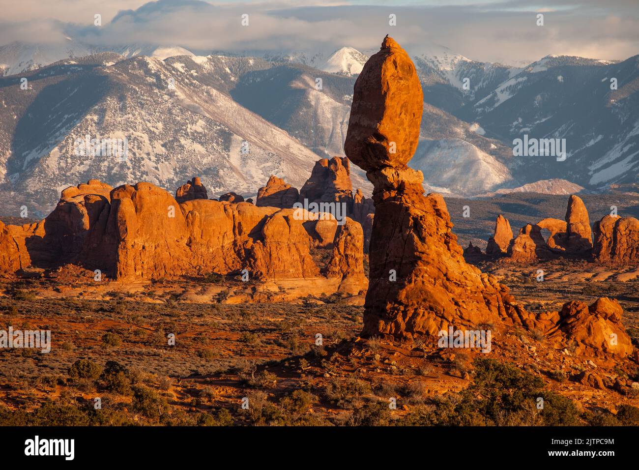 A telephoto view of Balanced Rock with Turret Arch and the La Sal ...