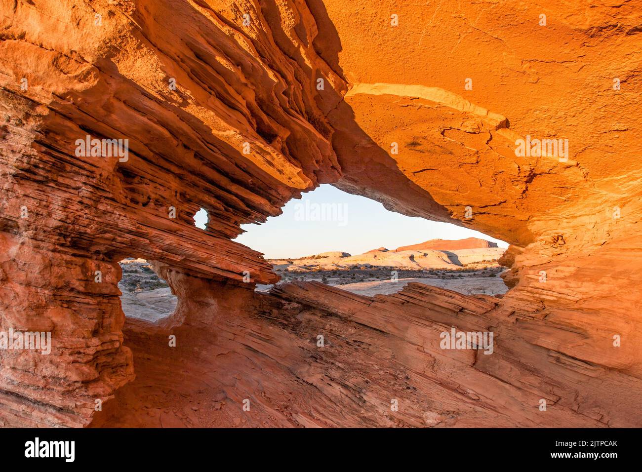 Multiple small arches in the colorful sandstone in the desert near Moab ...