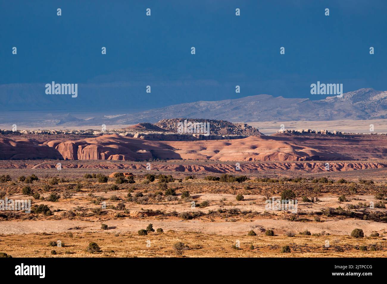 Desert landscape with stormy skies north of Moab, Utah. The white ...