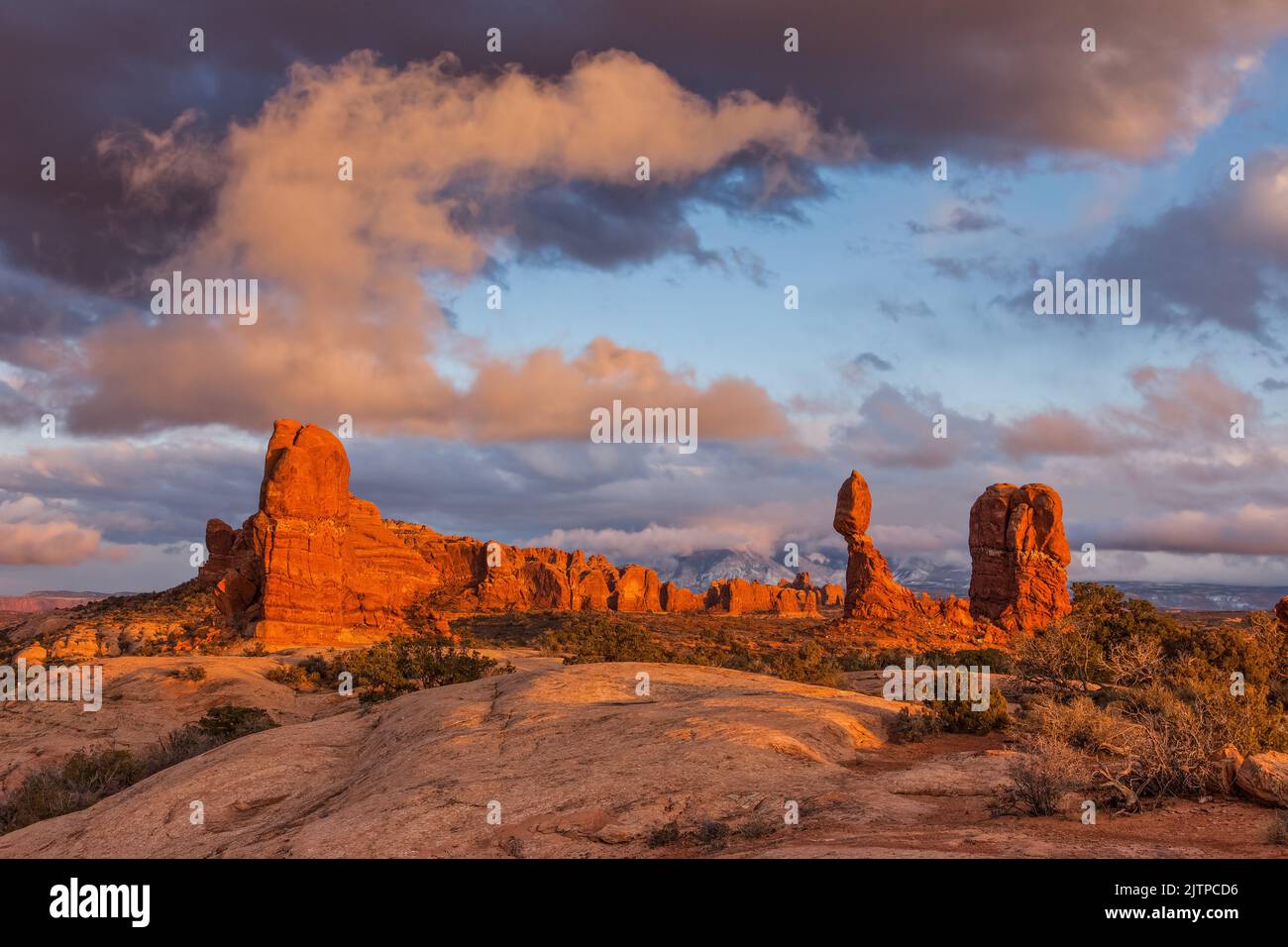 Balanced Rock at sunset in Arches National Park near Moab, Utah. In the background are the La ...
