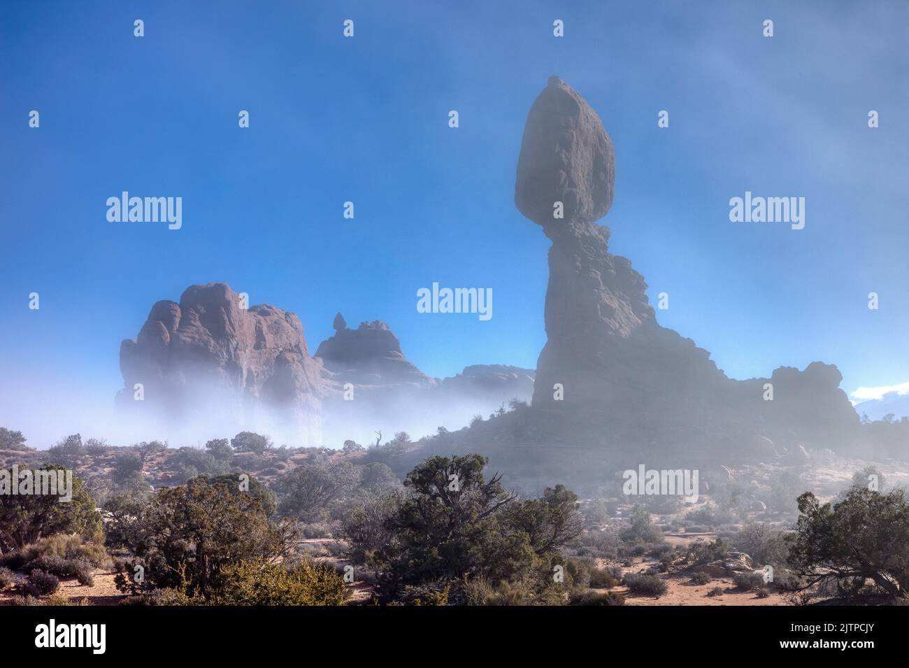 Clearing fog around Balanced Rock in winter in Arches National Park ...