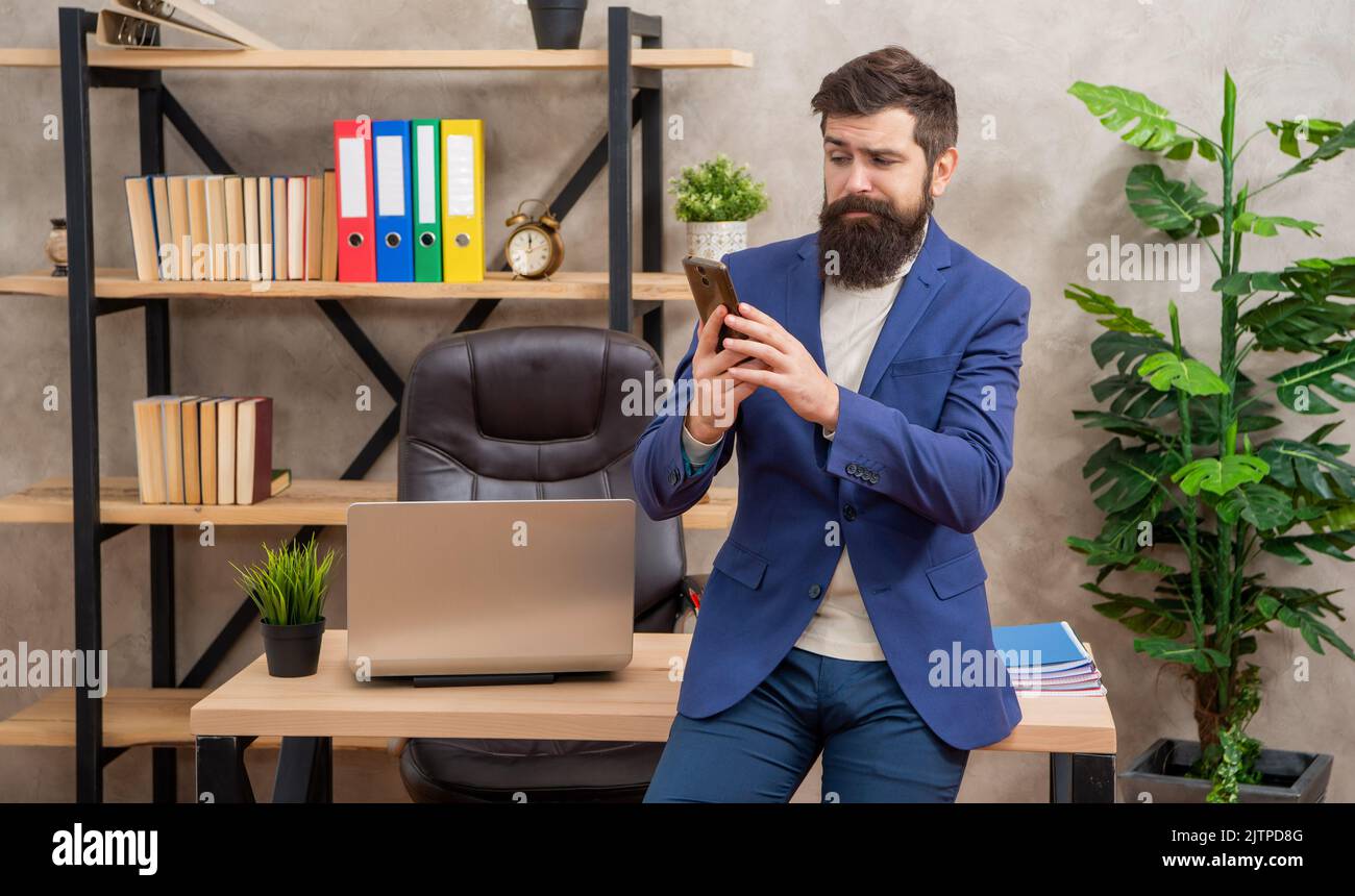 Incoming video call. Serious businessman having video call in office ...