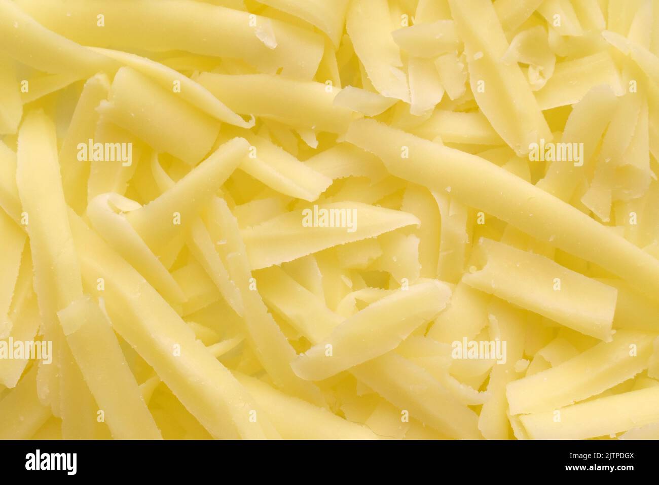 Grated cheese texture background Stock Photo - Alamy