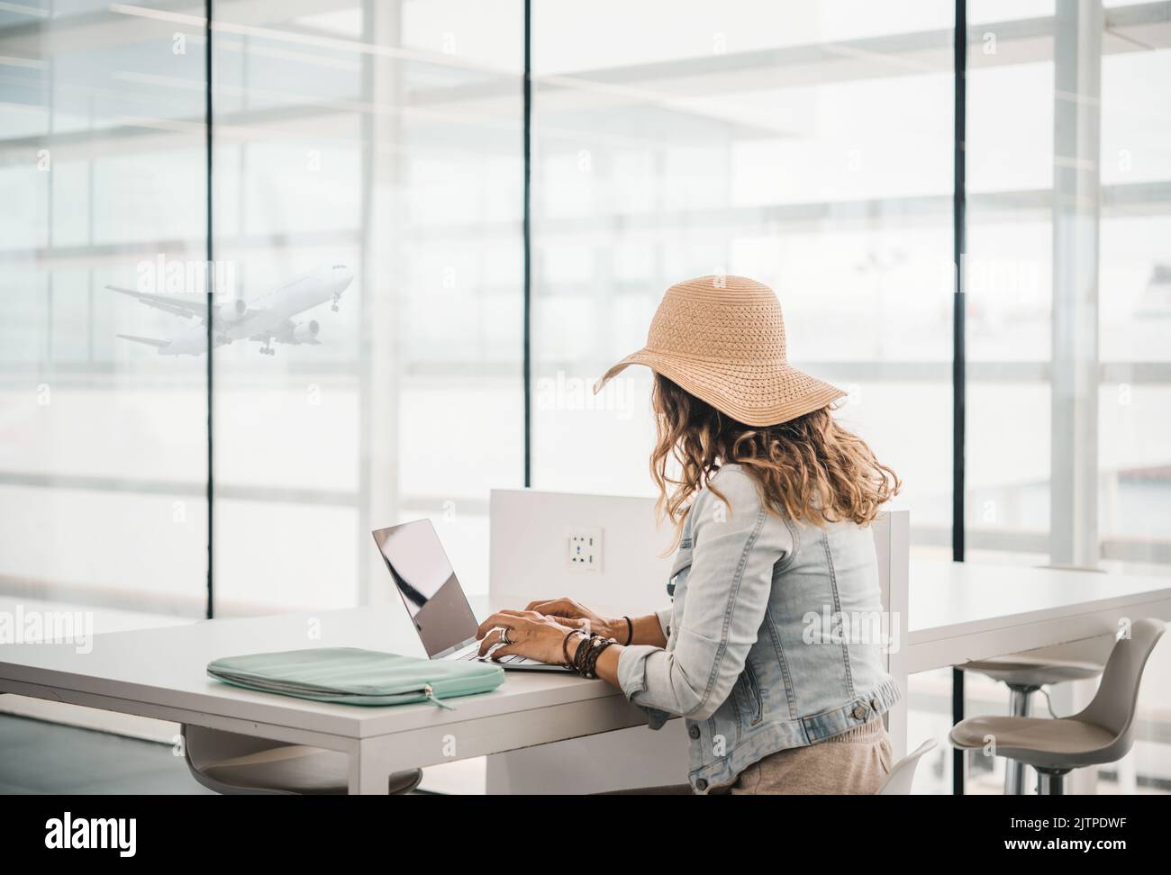 Anonymous female freelancer working in airport Stock Photo - Alamy