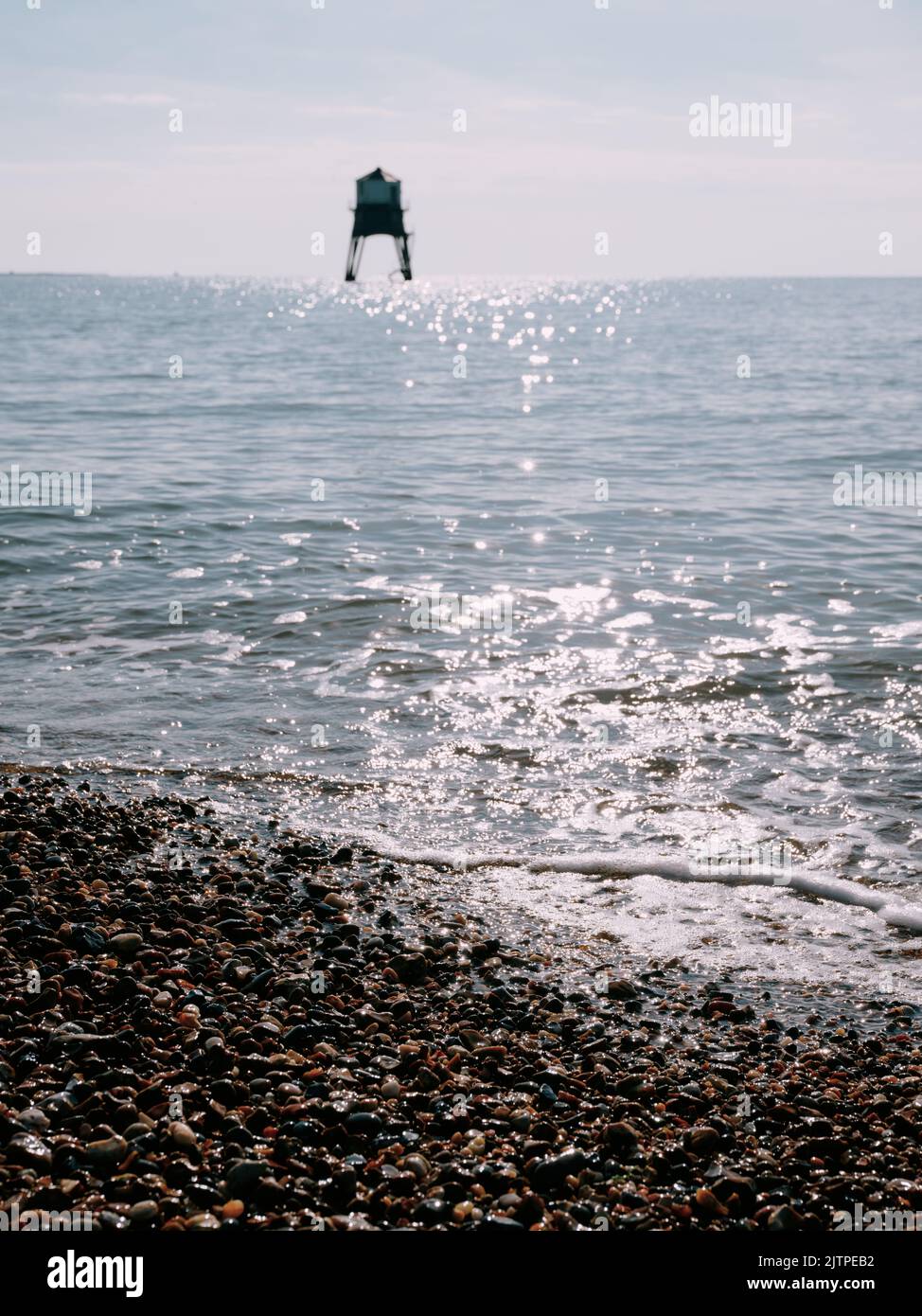 The Dovercourt Victorian Low Lighthouse and summer pebble beach and sea ...