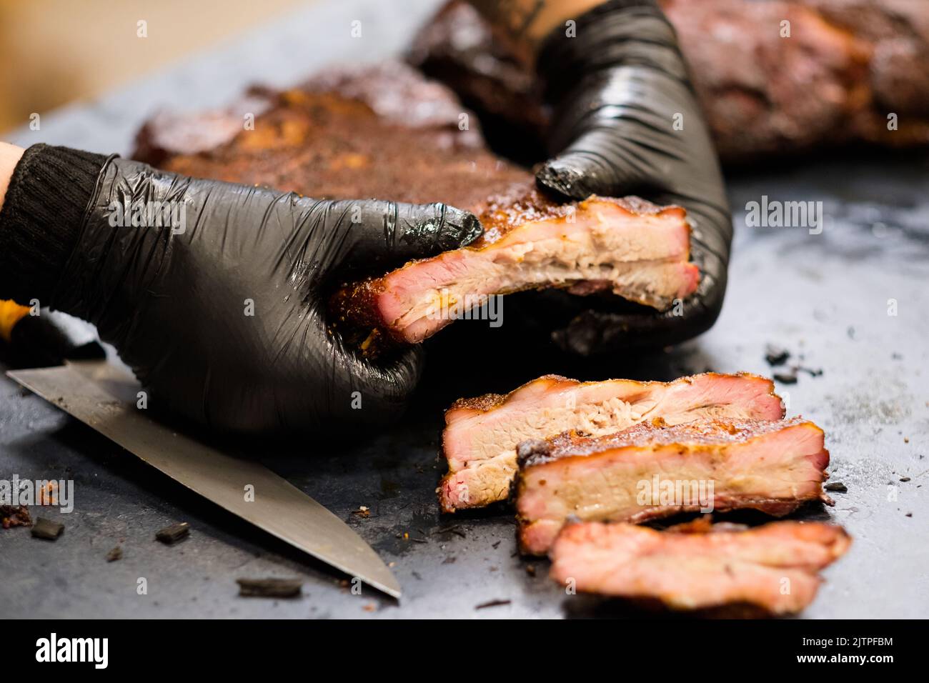 culinary master class chef gloves smoked pork ribs Stock Photo - Alamy