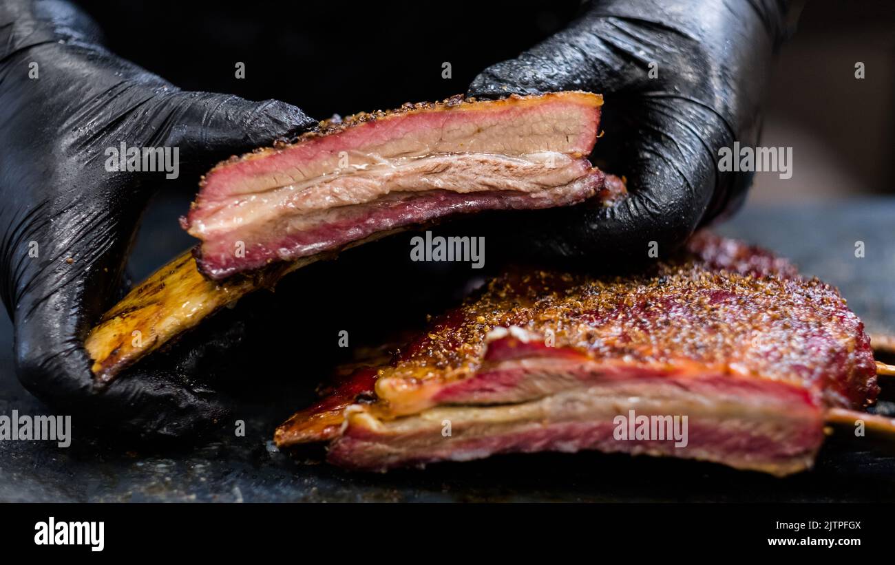 culinary master class chef gloves smoked beef ribs Stock Photo - Alamy
