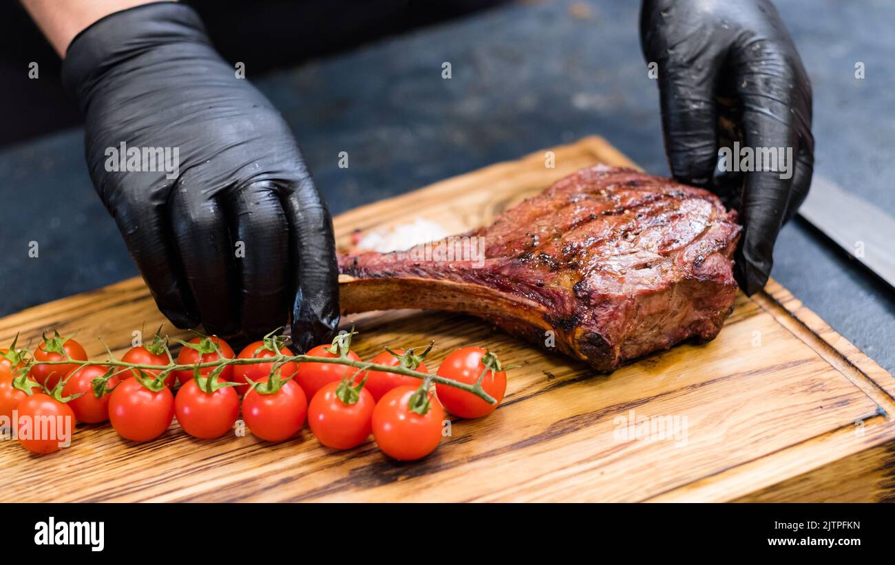 steakhouse kitchen cowboy steak cherry tomatoes Stock Photo - Alamy
