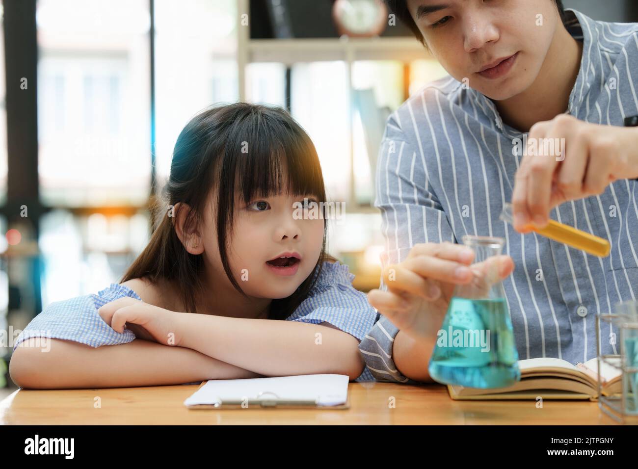 Girls and father doing science experiments. Education science concept ...