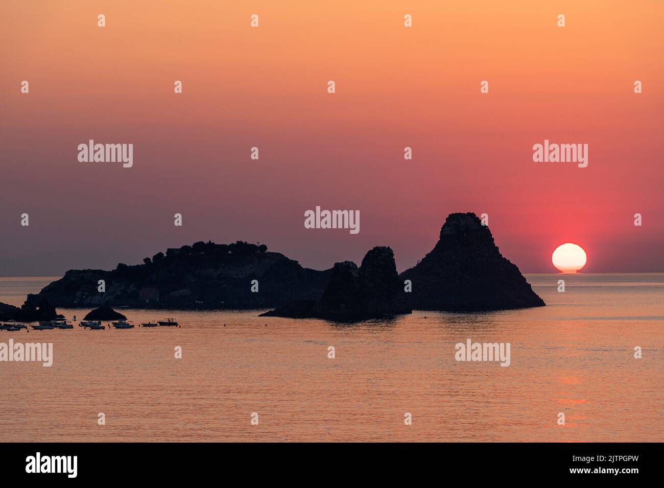 Sunrise behind the Faraglioni or Isole dei Ciclopi (Cyclopean Islands ...