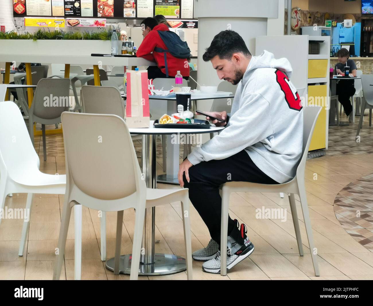 Moscow. Russia. August 31, 2022. A young man is sitting at a table in a ...