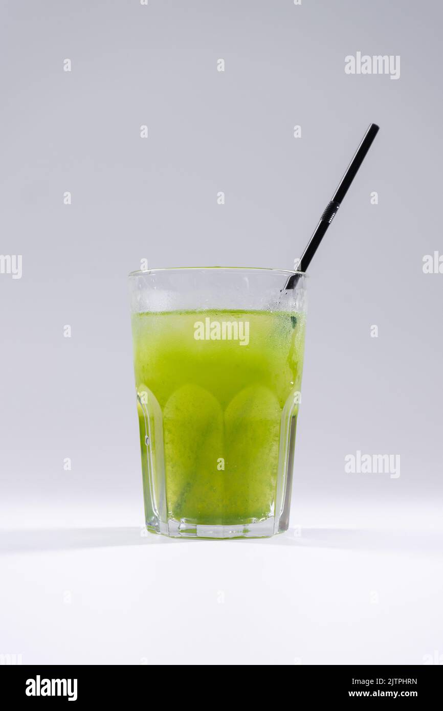 fresh cold fruit drink with green tarragon, ice, straw isolated Stock ...