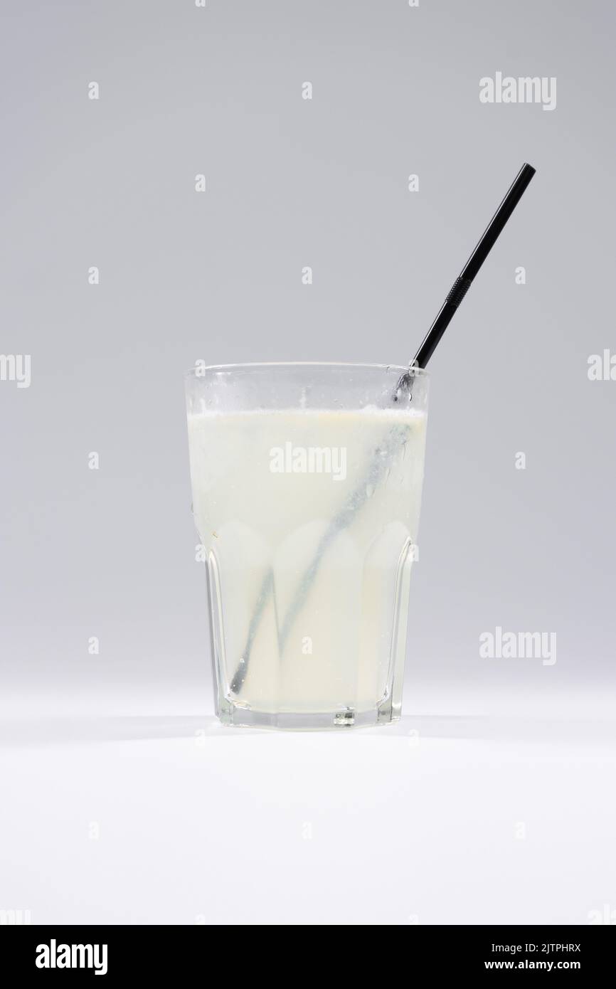 fresh cold fruit drink with mineral carbonated water, ice, straw isolated Stock Photo - Alamy
