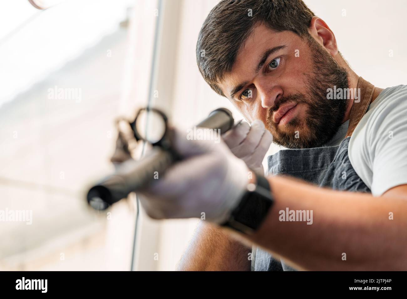 The gunsmith maintaining his rifle in a workshop Stock Photo - Alamy