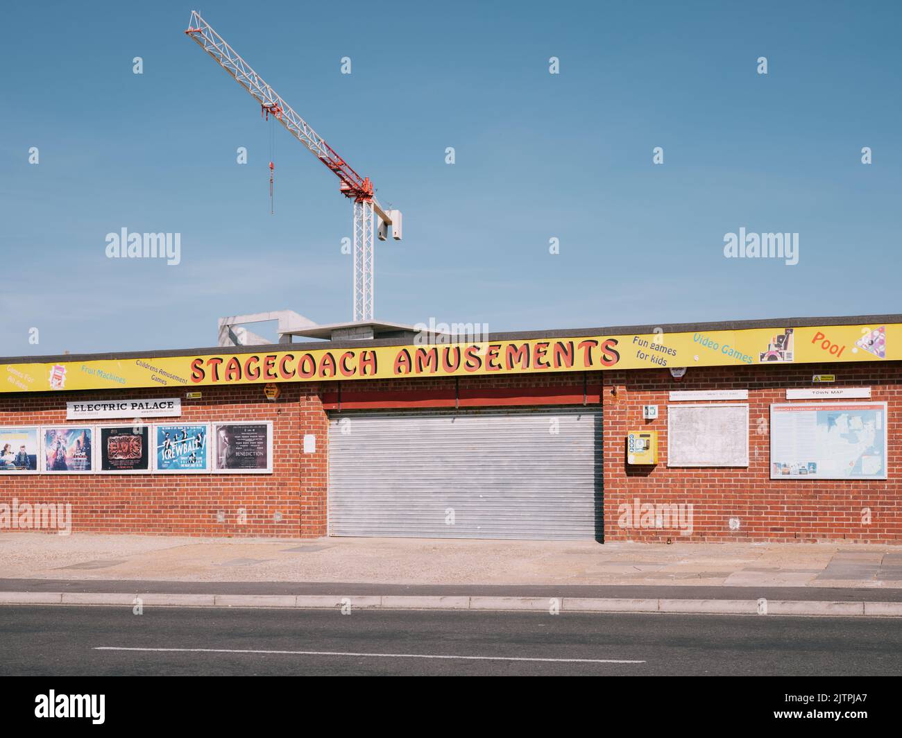 A closed Stagecoach amusement arcade with a high rise building crane ...