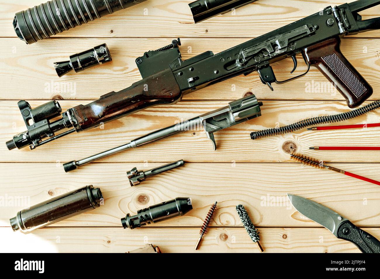 Disassembled rifle with cleaning tools on table of weapons workshop ...