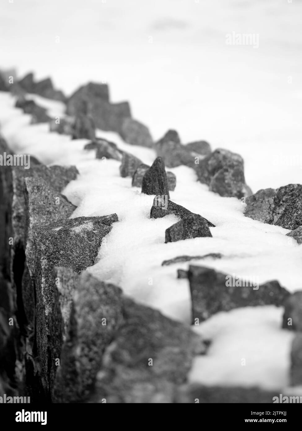 A vertical closeup of rocks covered with snow Stock Photo - Alamy