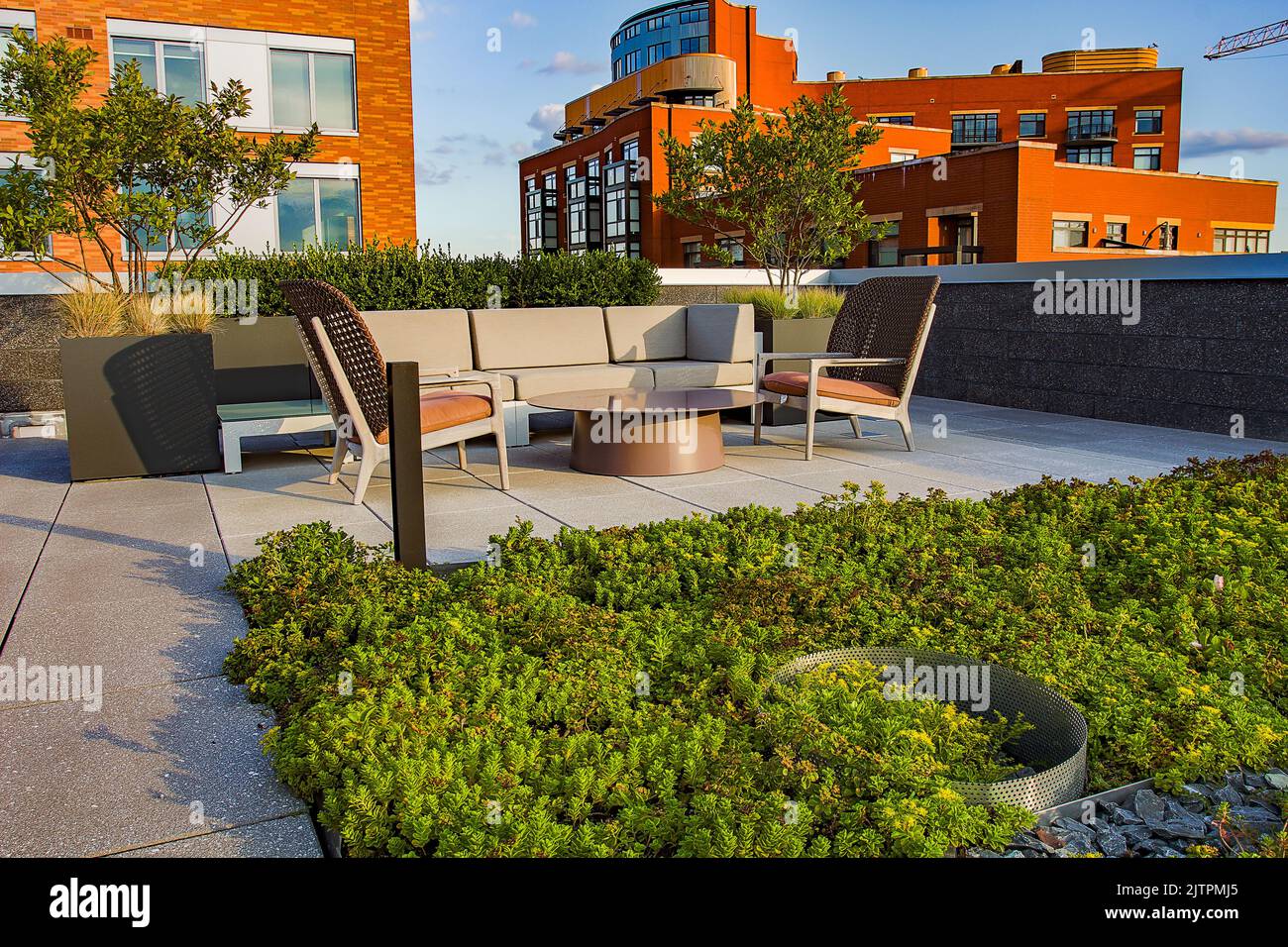 A sitting area on an apartment rooftop in the evening, taken by a canon ...