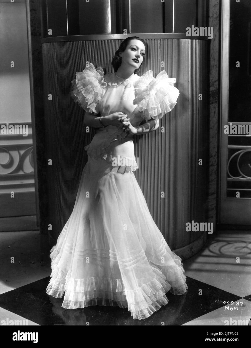 JOAN CRAWFORD Portrait by GEORGE HURRELL in gown by GILBERT ADRIAN worn ...