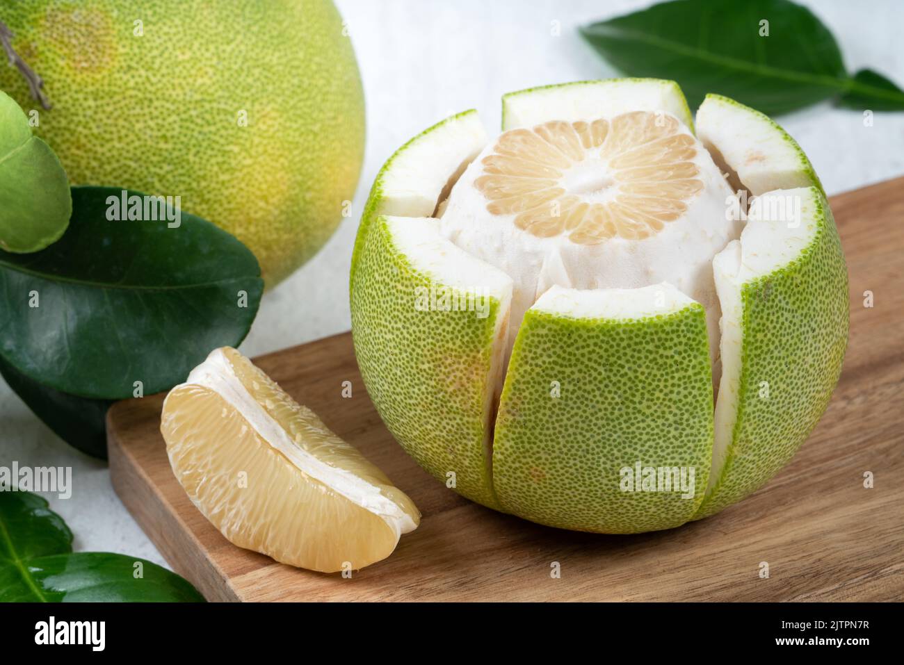 Close up of fresh peeled pomelo on white table background for Mid ...