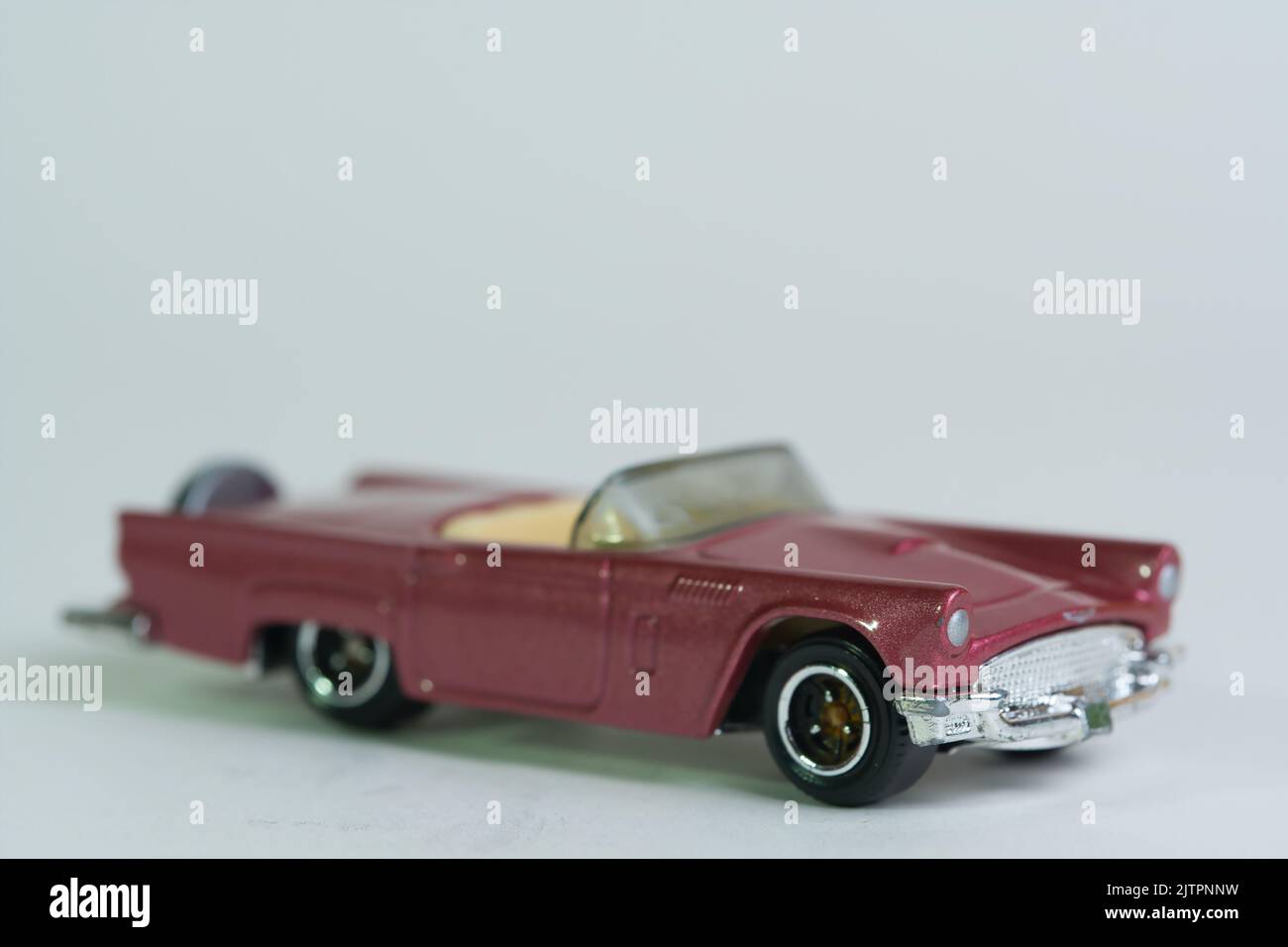 pink cabriolet retro toy car on white background, model car, front view ...