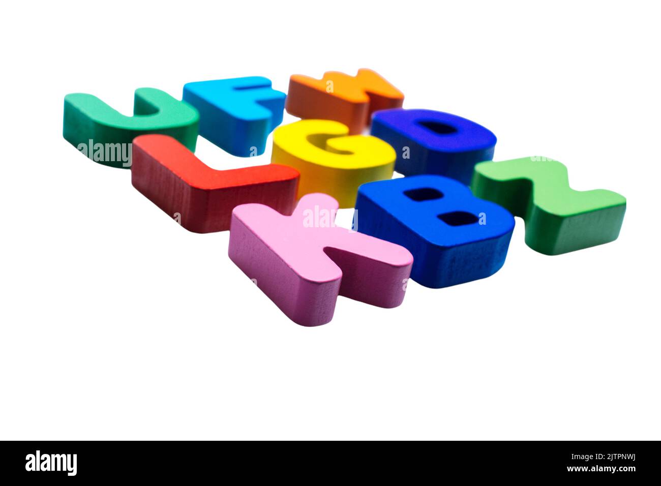 Colored wooden letters of the English alphabet on a white background ...