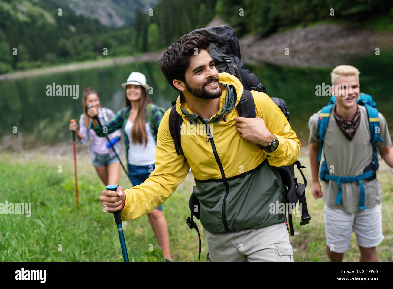 Group of fit healthy friends trekking in the mountains Stock Photo - Alamy