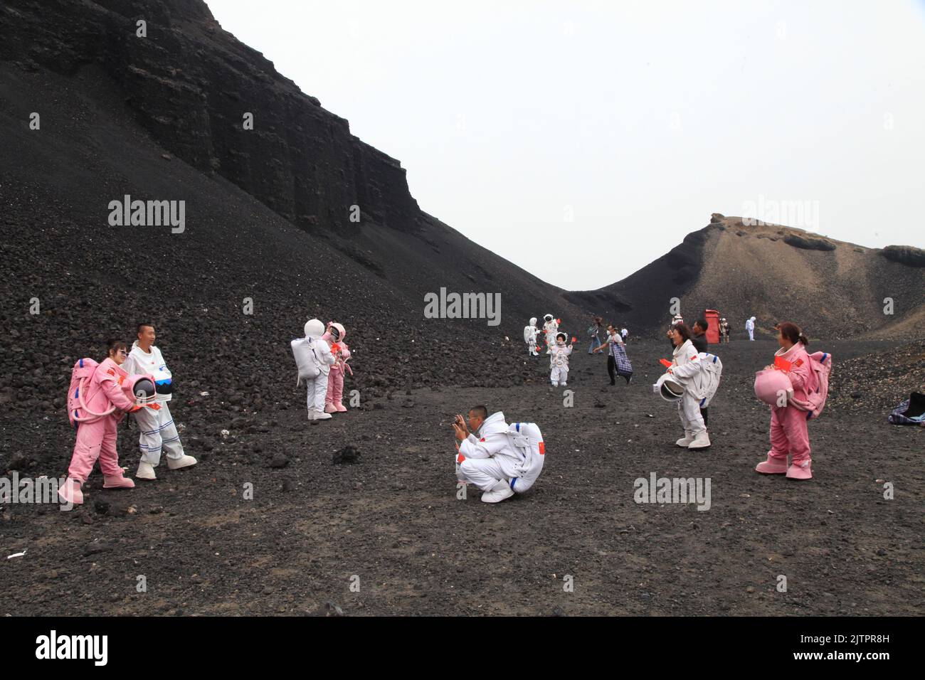 ULANQAB, CHINA - JULY 27, 2022 - Tourists wearing spacesuits pose with ...