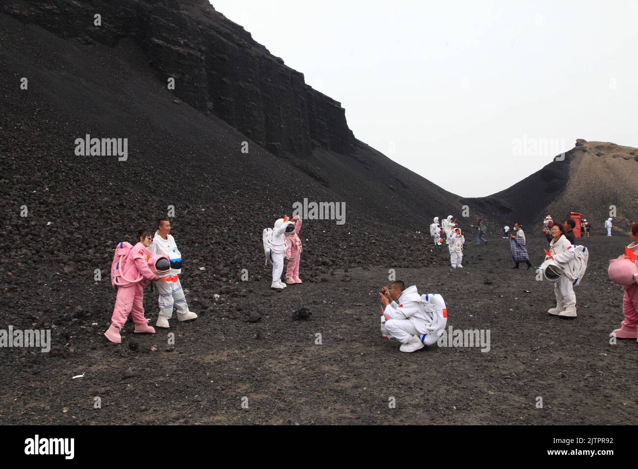 ULANQAB, CHINA - JULY 27, 2022 - Tourists wearing spacesuits pose with ...