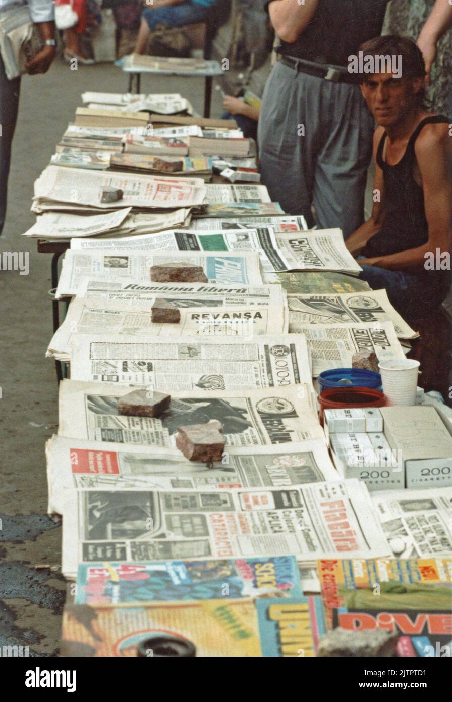 Bucharest, Romania, 1990. Men selling newspapers and magazines on the ...