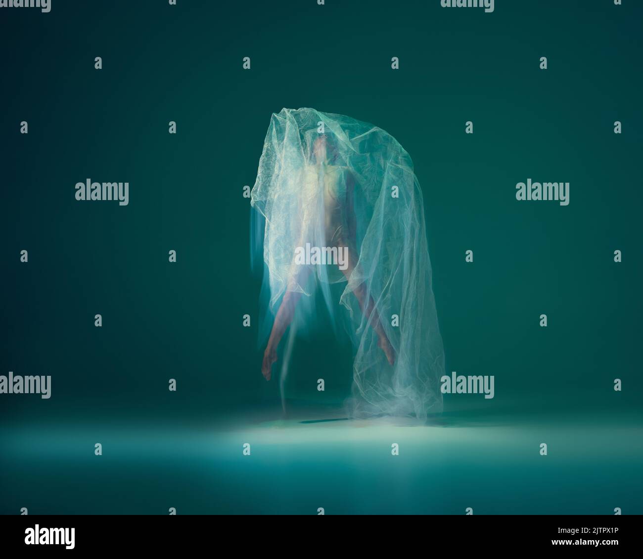 Graceful ballet dancer dancing with white cloth, fabric isolated on ...