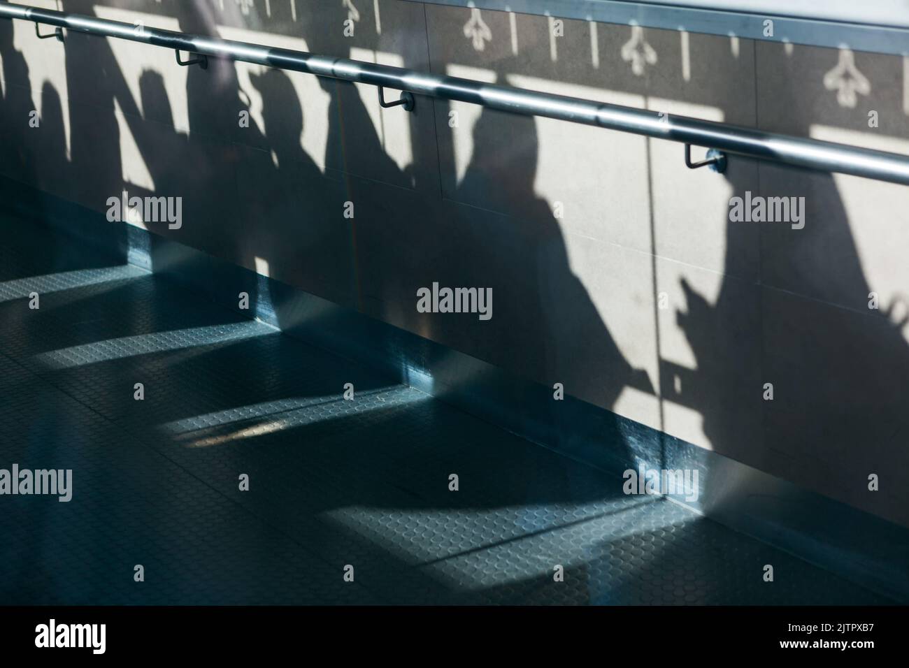 People silhouettes on the wall . Humans abstract light and shadow Stock ...