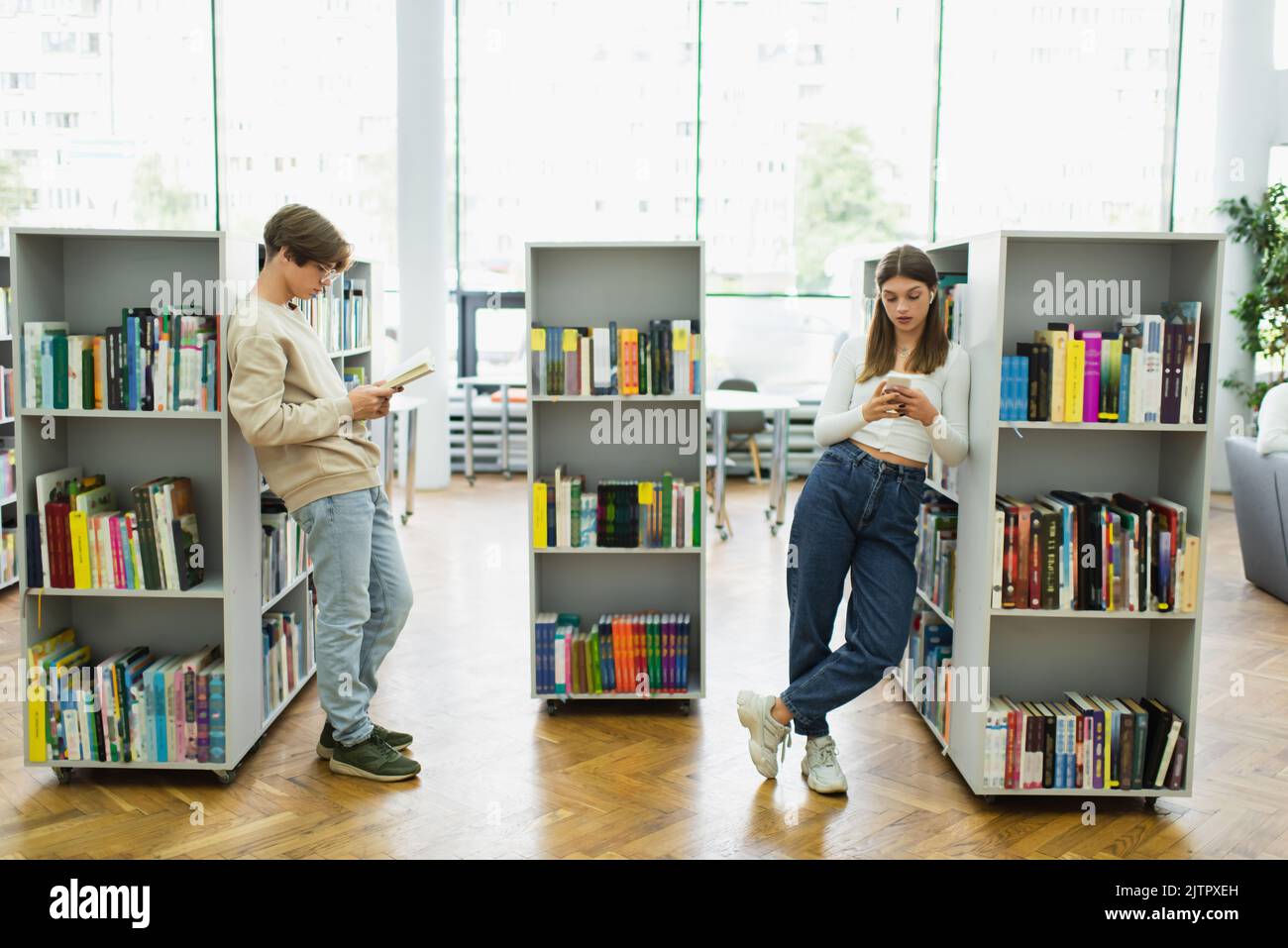 Girl with book boy standing hi-res stock photography and images - Alamy