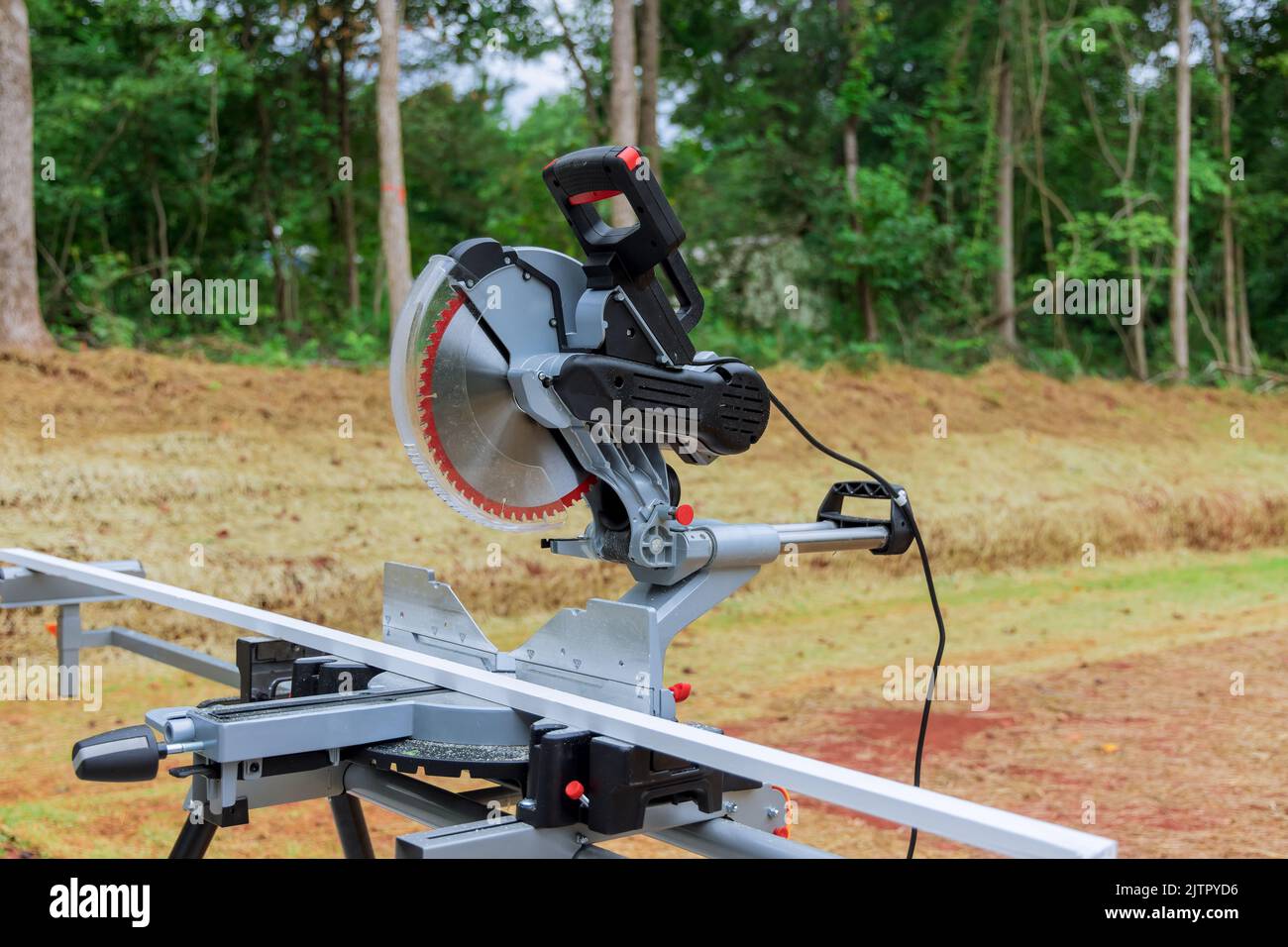 Circular miter saw on a saw stand with under construction a new home ...