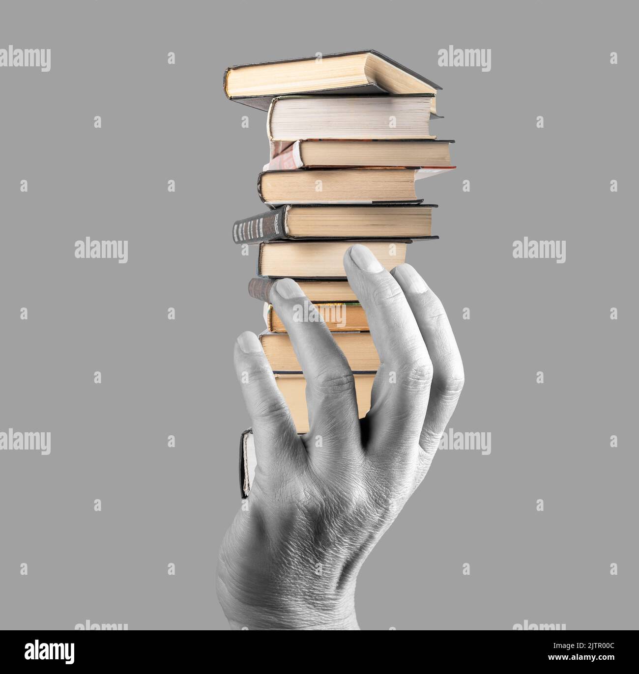 Hand holding books stack on grey background. Knowledge, intellectual ...