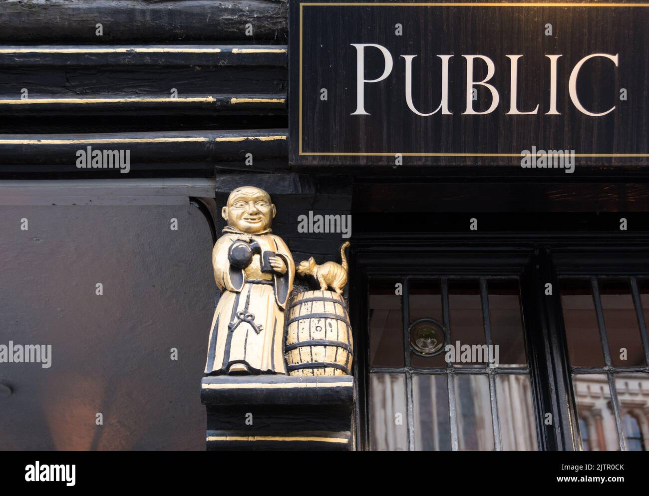 Closeup of wood carvings of monks on the half-timbered George Public ...