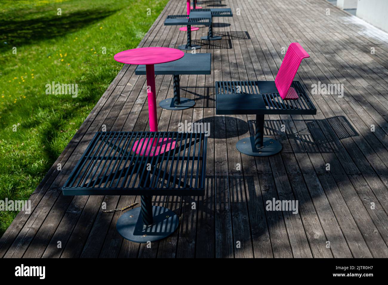 colorful metal benches and tables on the terrace on a sunny day Stock ...