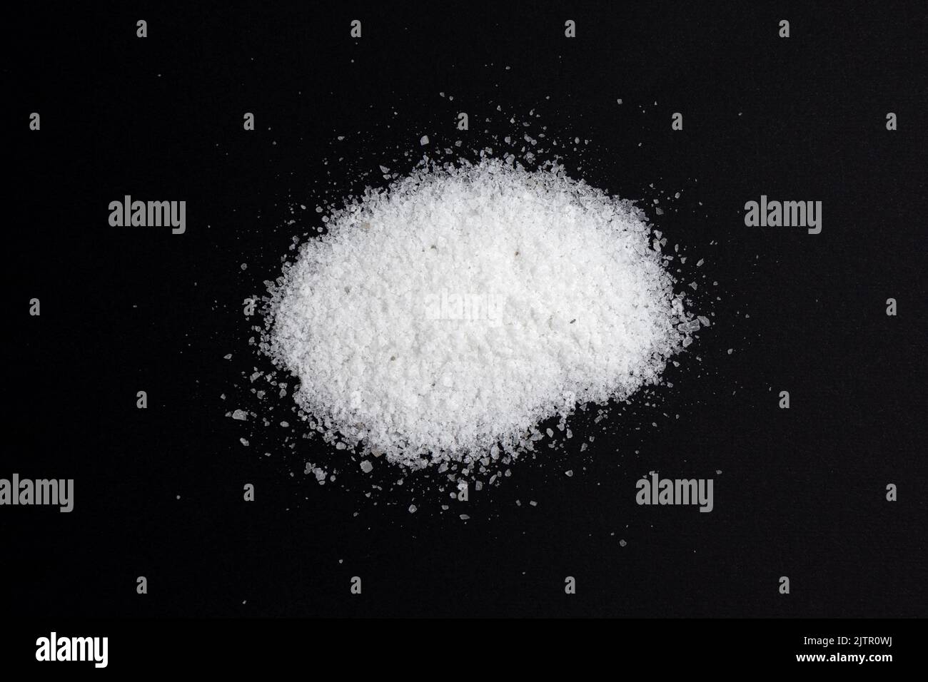 pile of kitchen salt, mineral sea salt isolated on black background ...