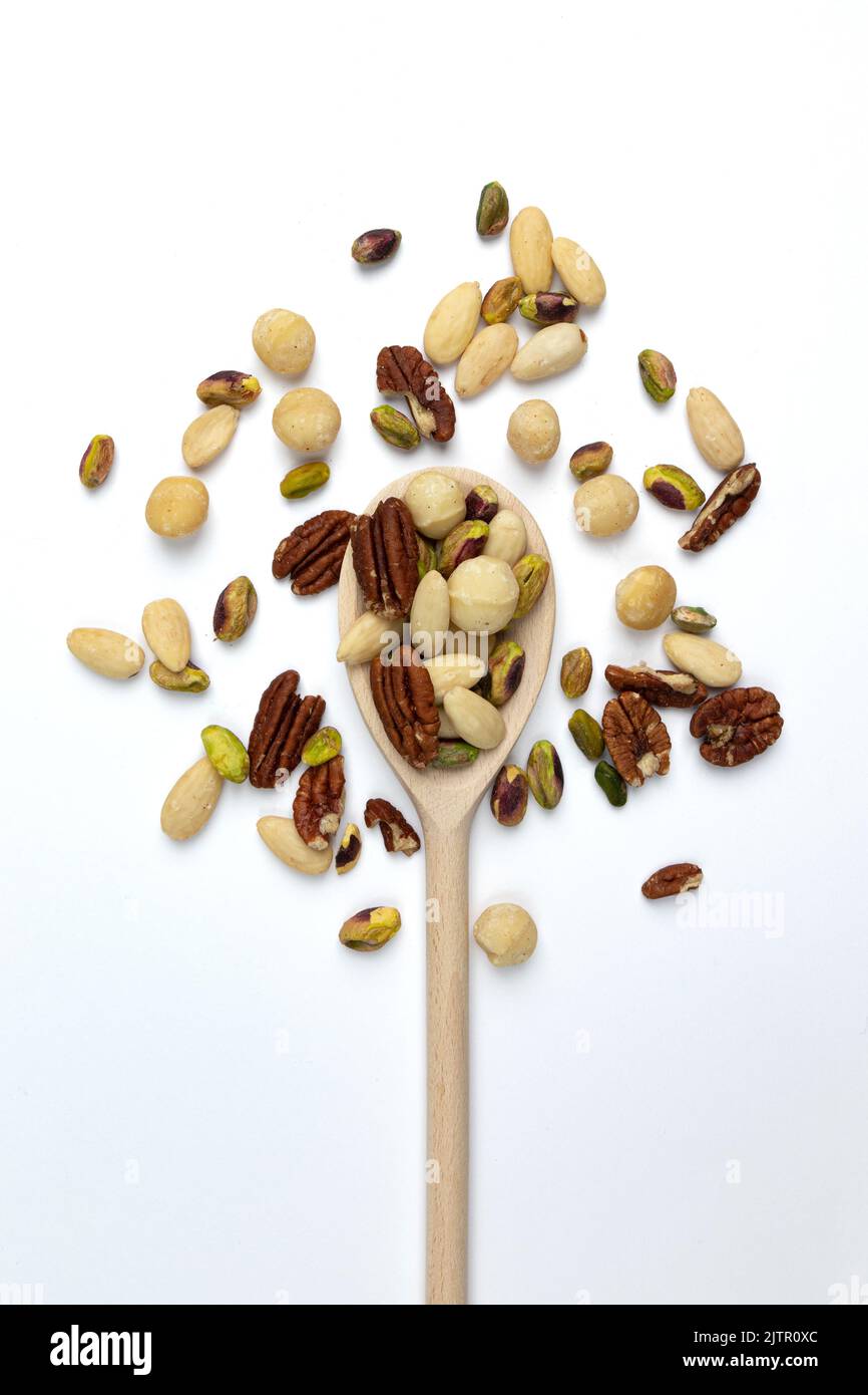 mixed nuts in wooden spoon isolated on white background, top view ...