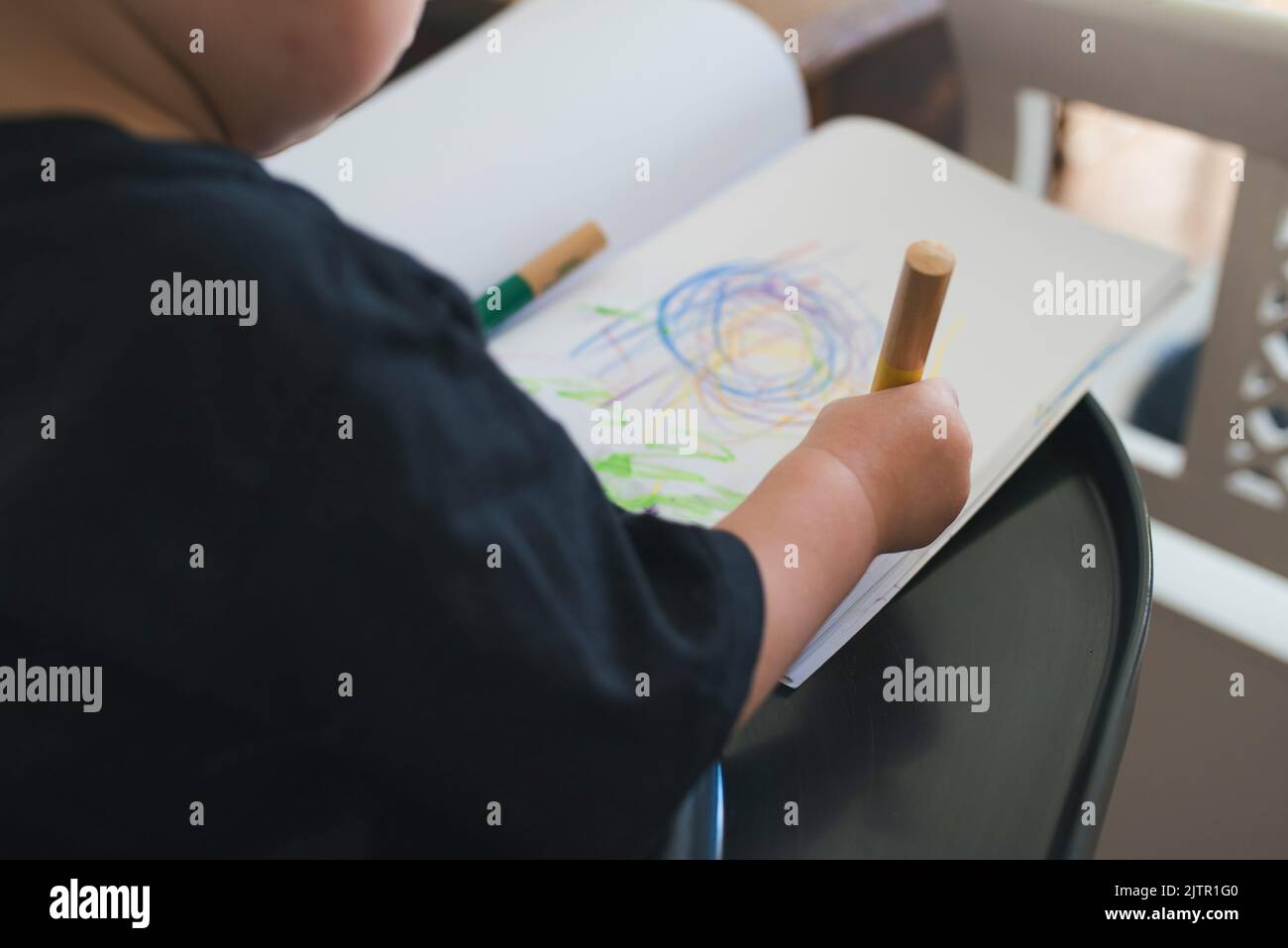 close-up view of toddler using crayons to draw a picture Stock Photo ...