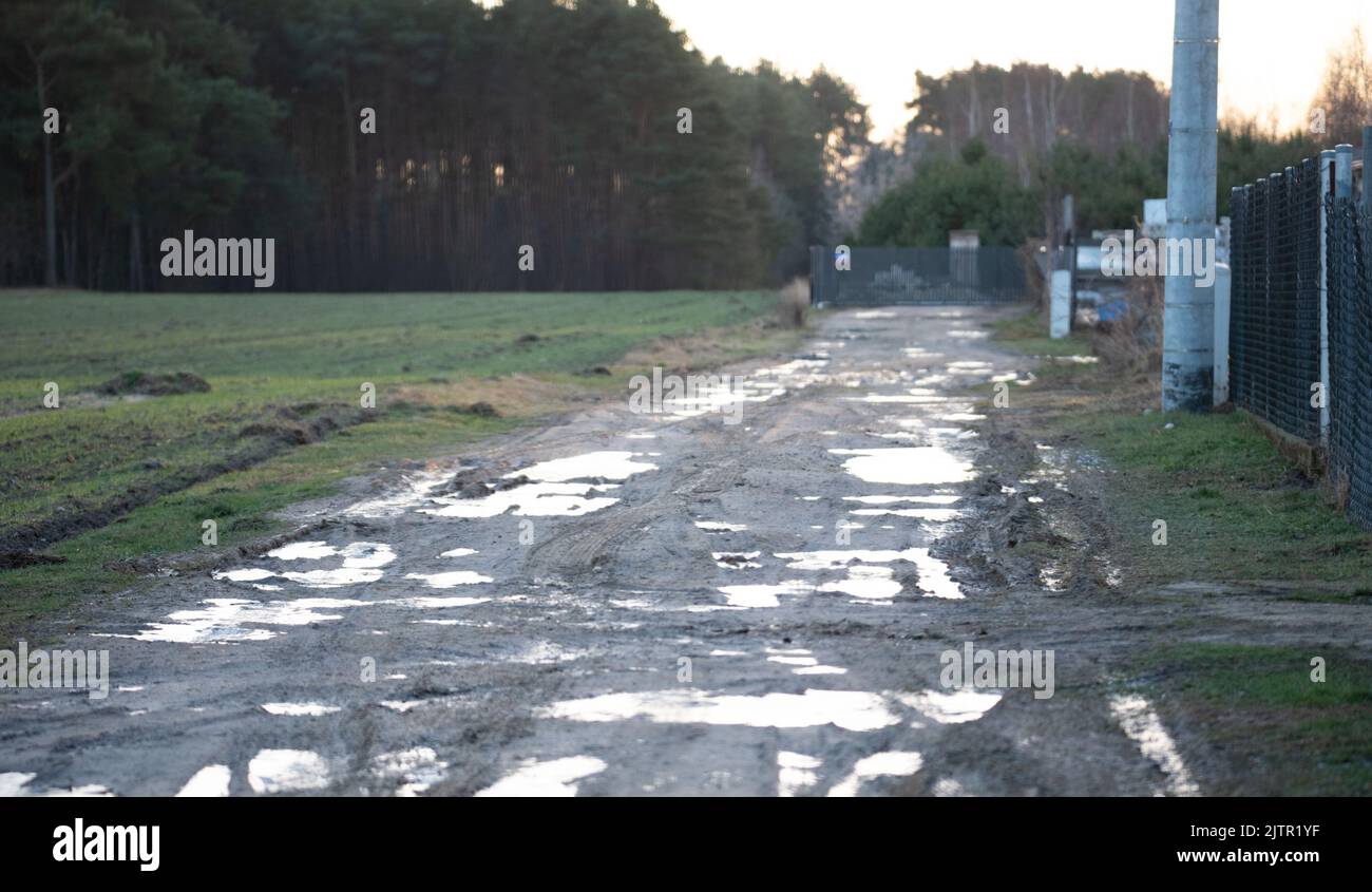 Dirt road after rain. Puddles and mud on the road Stock Photo - Alamy
