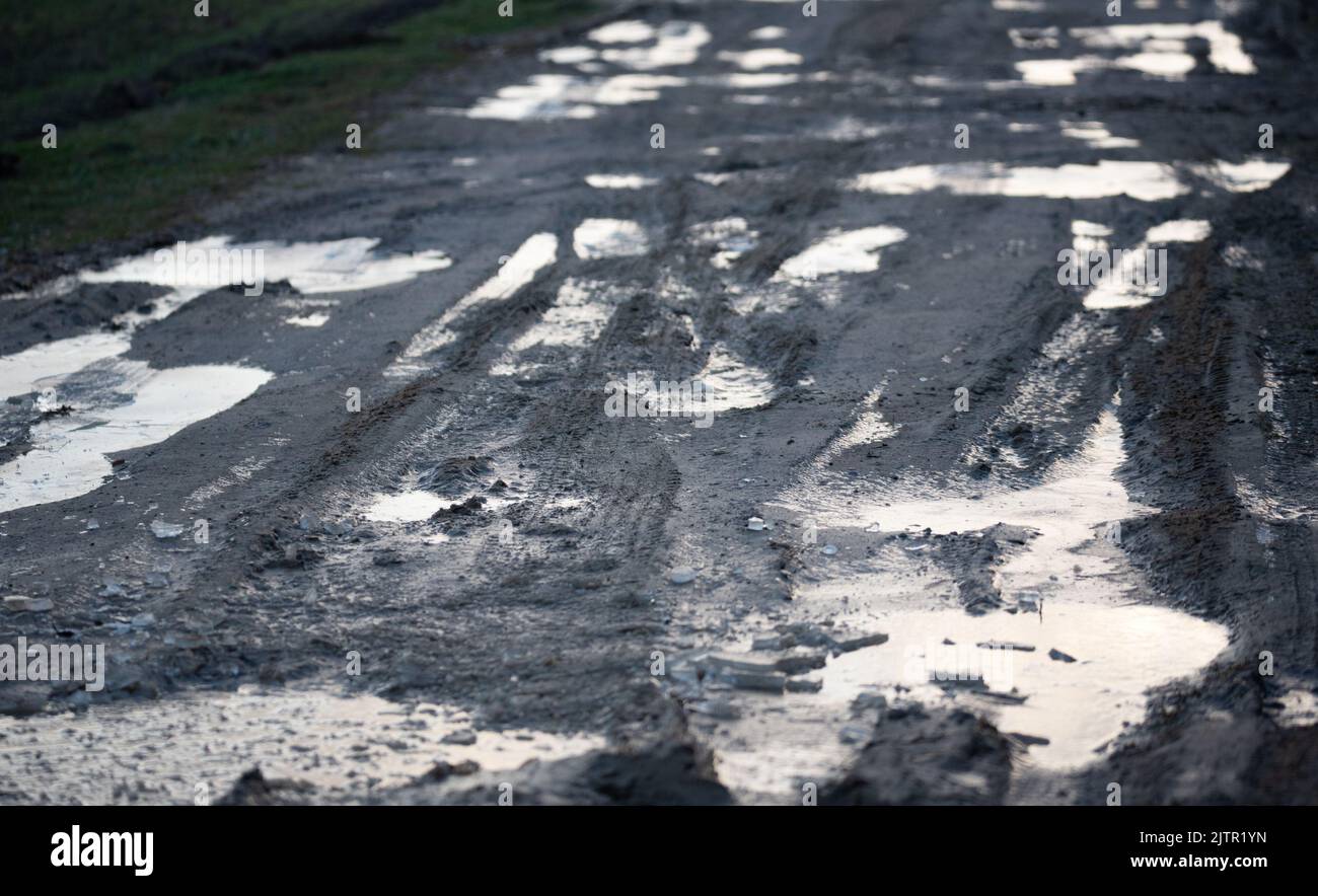 Dirt road after rain. Puddles and mud on the road Stock Photo - Alamy