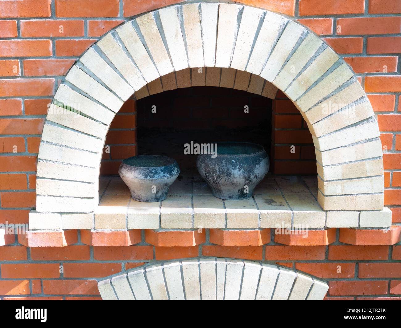 front view of pots in brick russian stove outdoors Stock Photo - Alamy