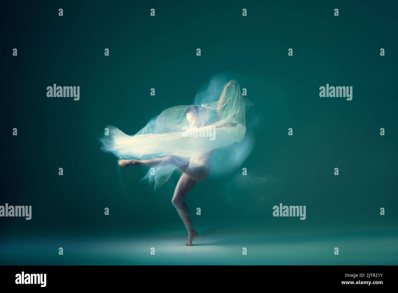 Graceful ballet dancer dancing with white cloth, fabric isolated on ...