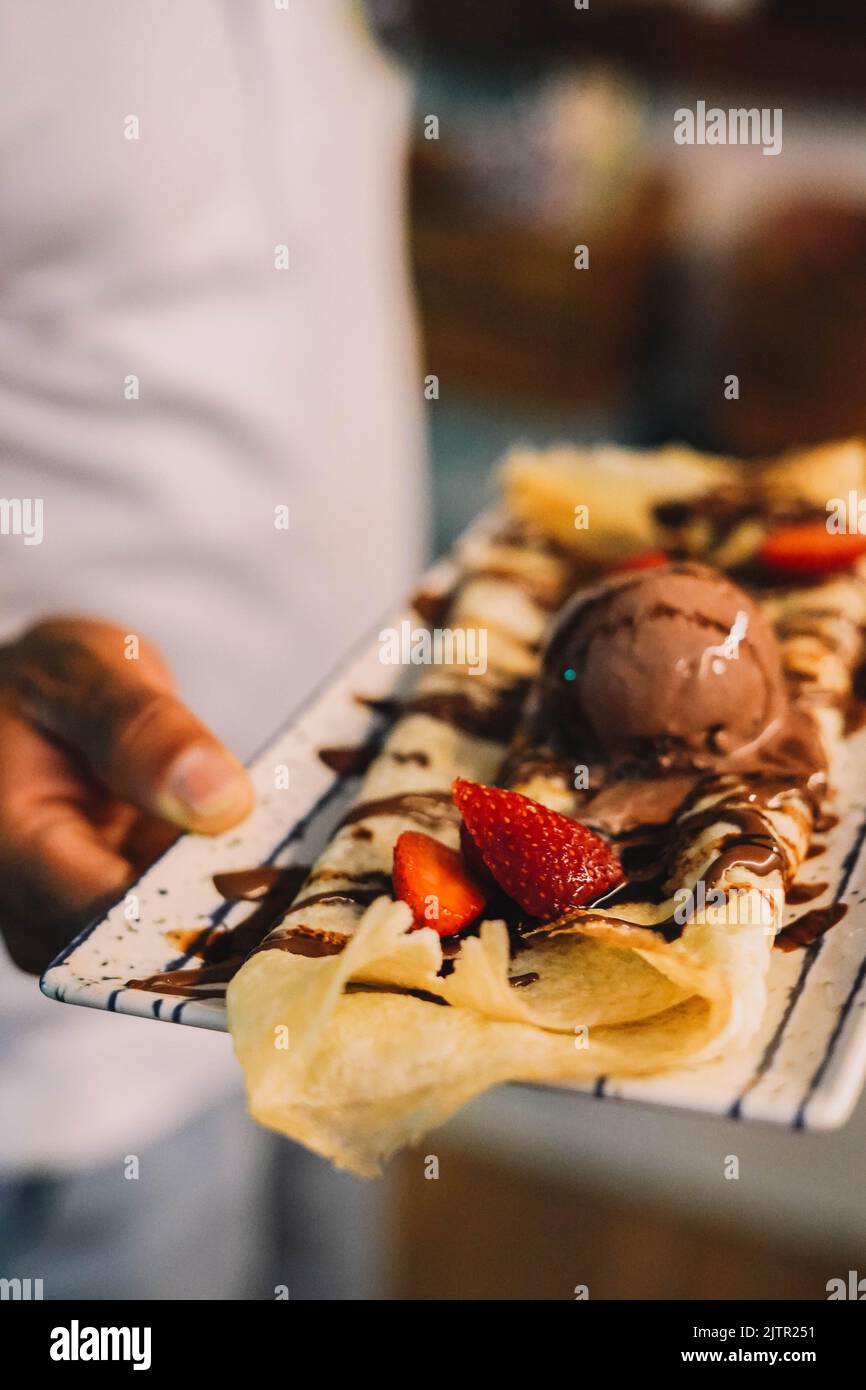 Delicious nutella and chocolate syrup crepe, with a scoop of ice cream ...